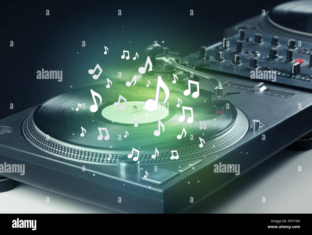 Turntable playing music with audio notes glowing Stock Photo - Alamy