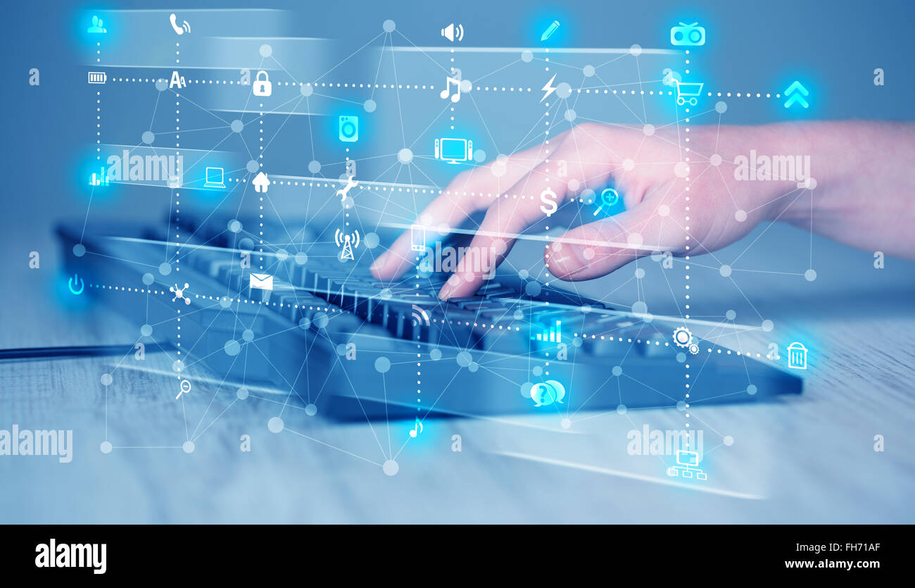 Hand pressing keyboard with high tech media icons Stock Photo - Alamy