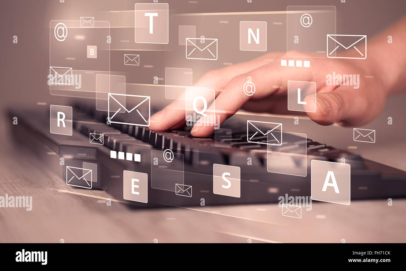 Hand typing on keyboard with digital tech icons Stock Photo - Alamy