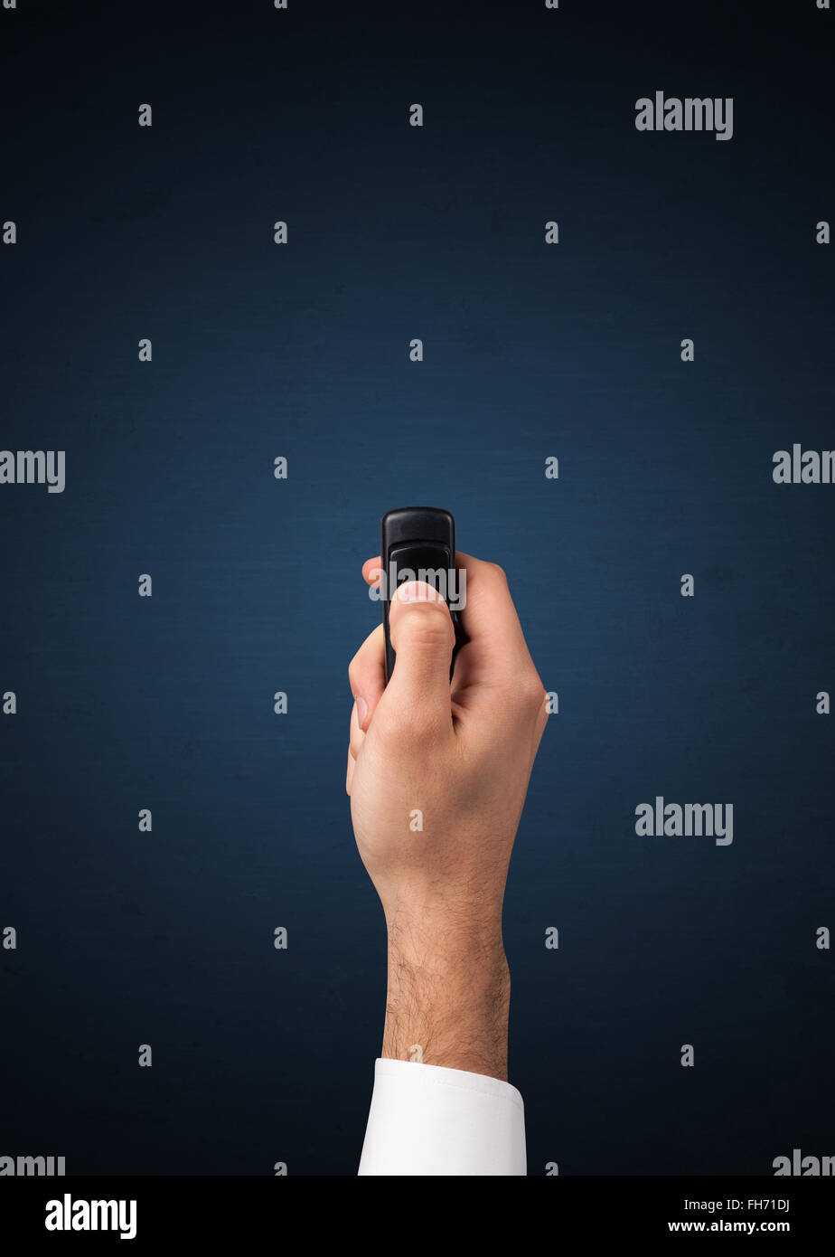 Hand with remote control Stock Photo - Alamy