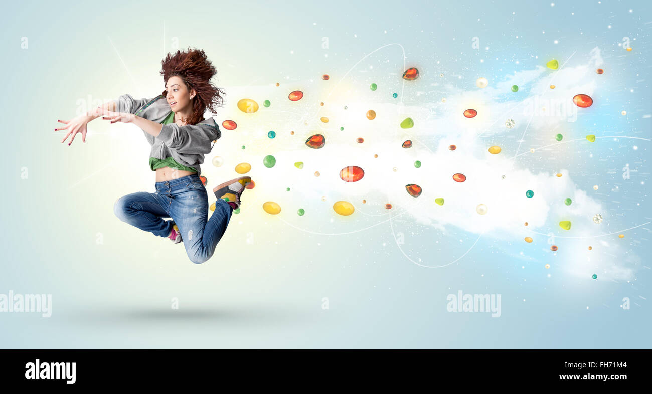 Beautiful woman jumping with colorful gems and crystals on the ...