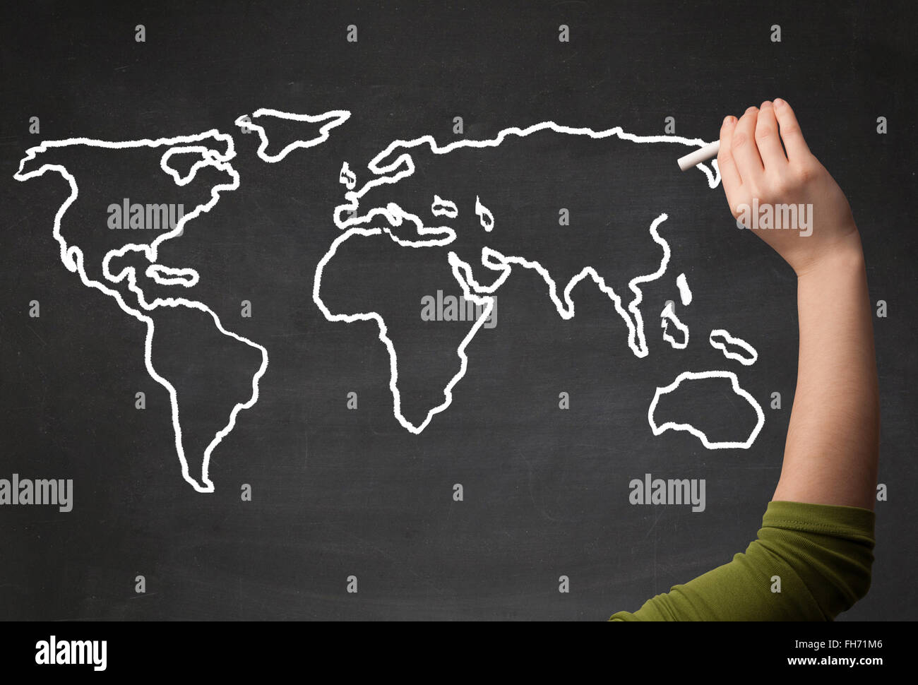 Adult drawing world map on chalkboard Stock Photo - Alamy