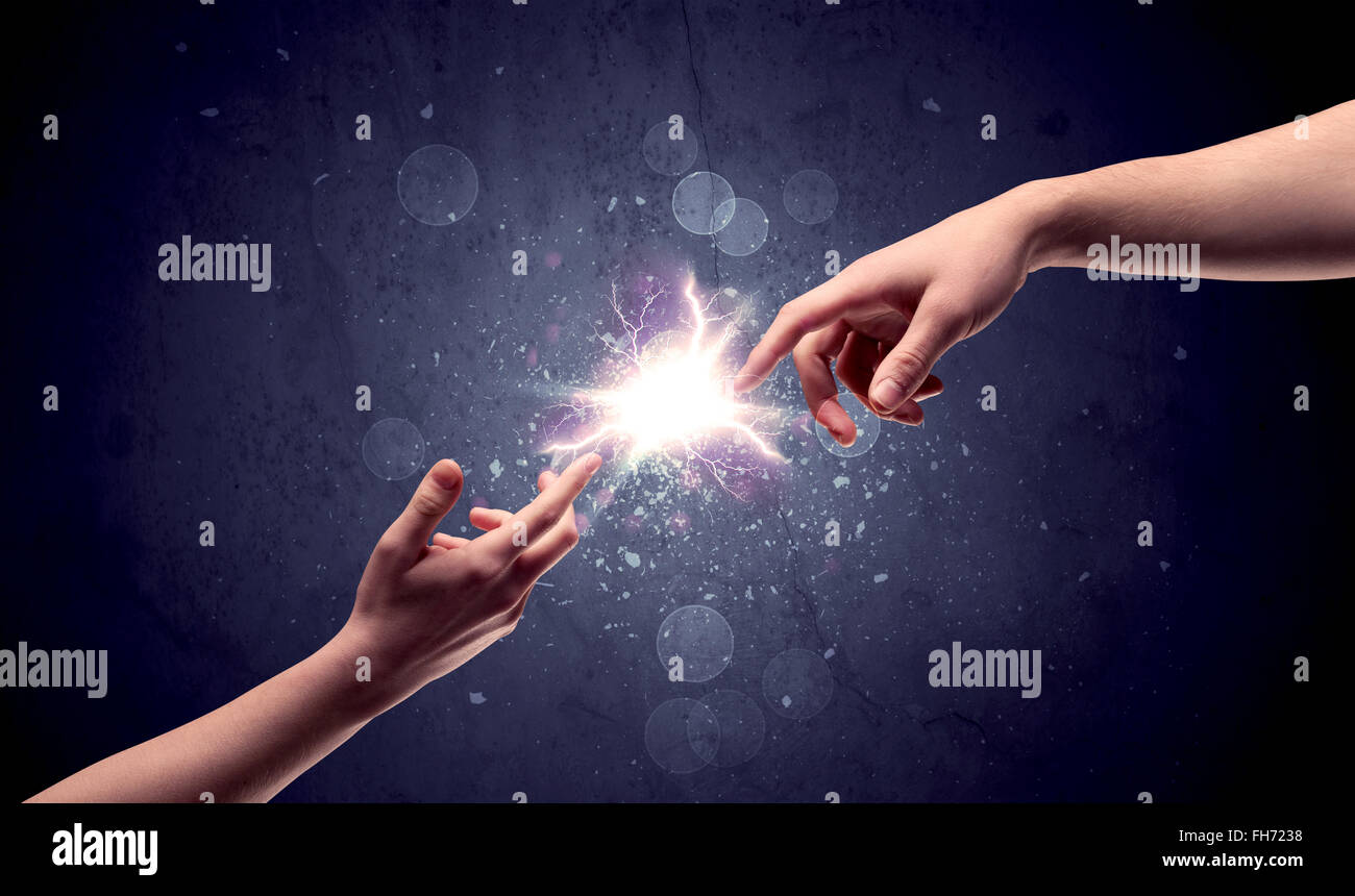 Hands reaching to light a spark Stock Photo - Alamy