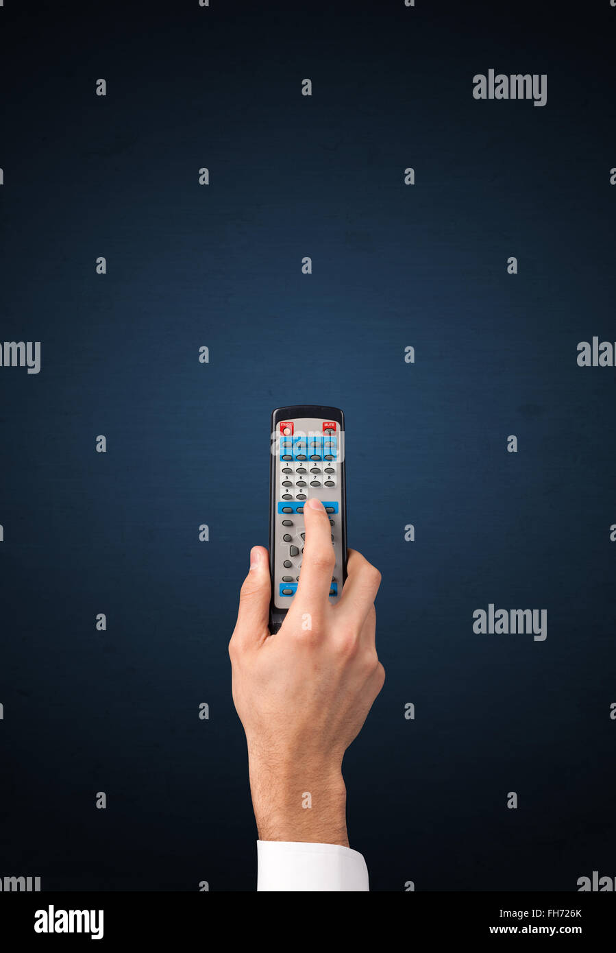 Hand with remote control Stock Photo - Alamy