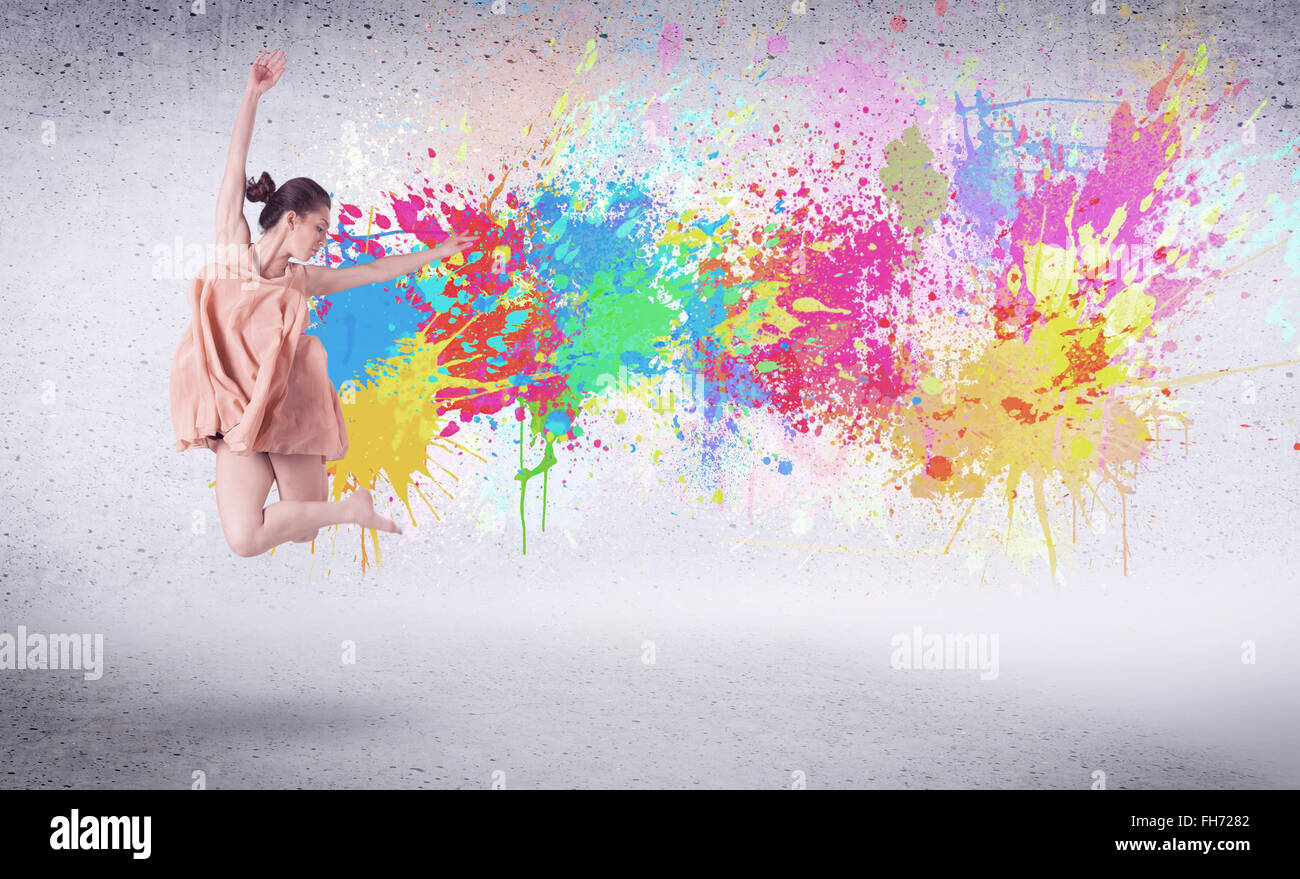 Modern street dancer jumping with colorful paint splashes Stock Photo ...