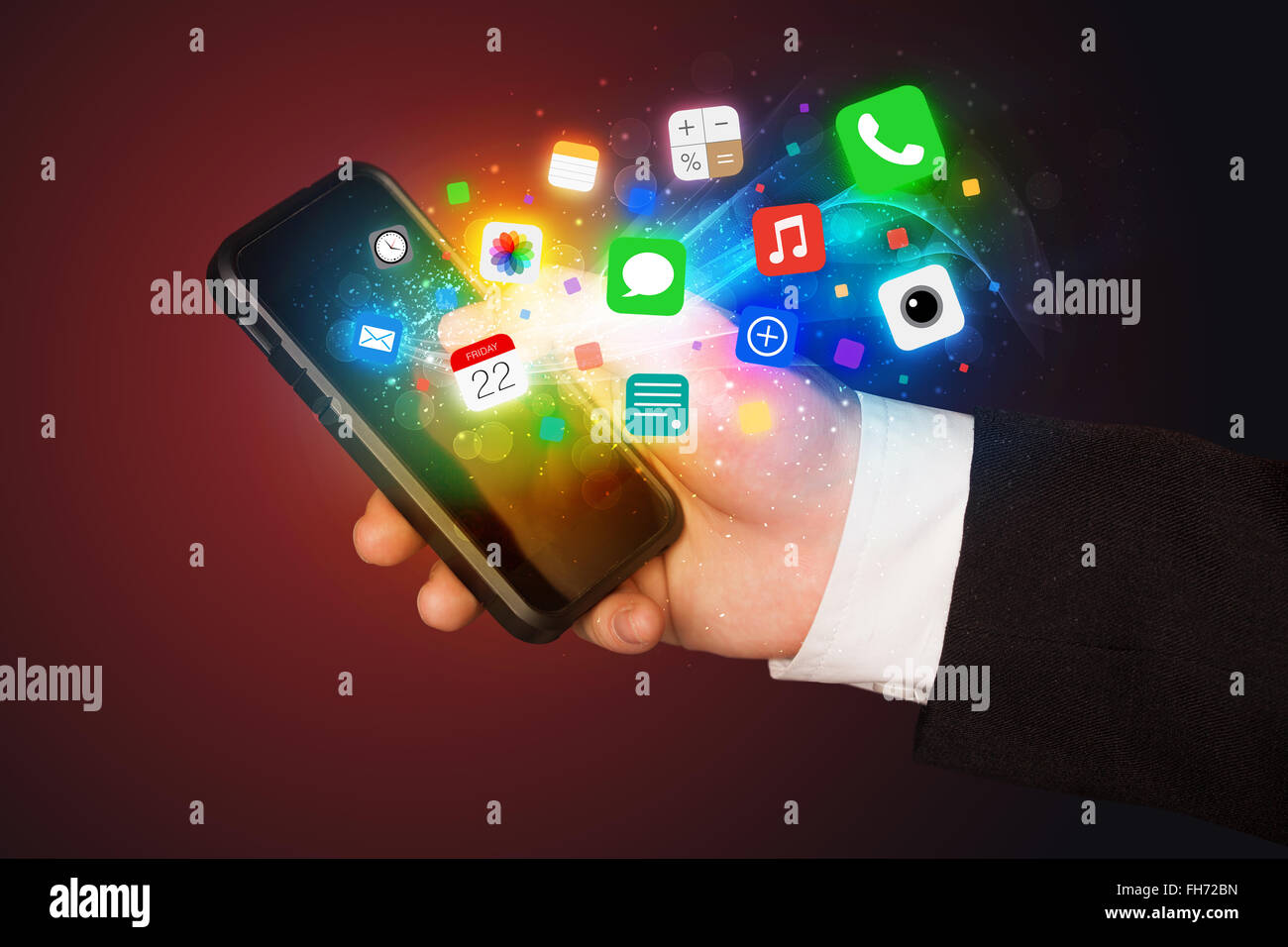 Hand holding smartphone with colorful app icons Stock Photo - Alamy