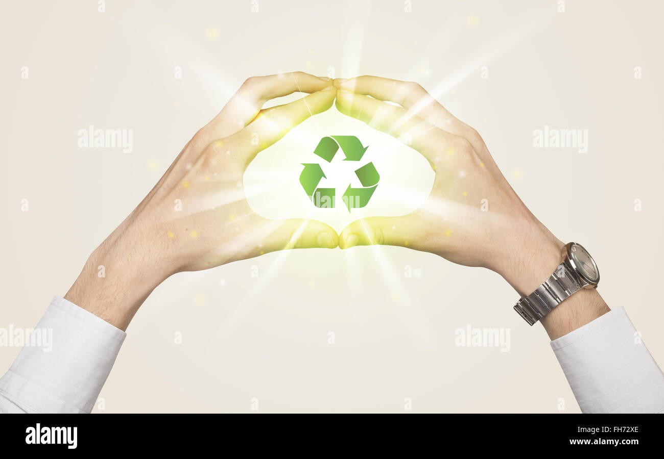 Hands creating a form with recycling sign Stock Photo - Alamy