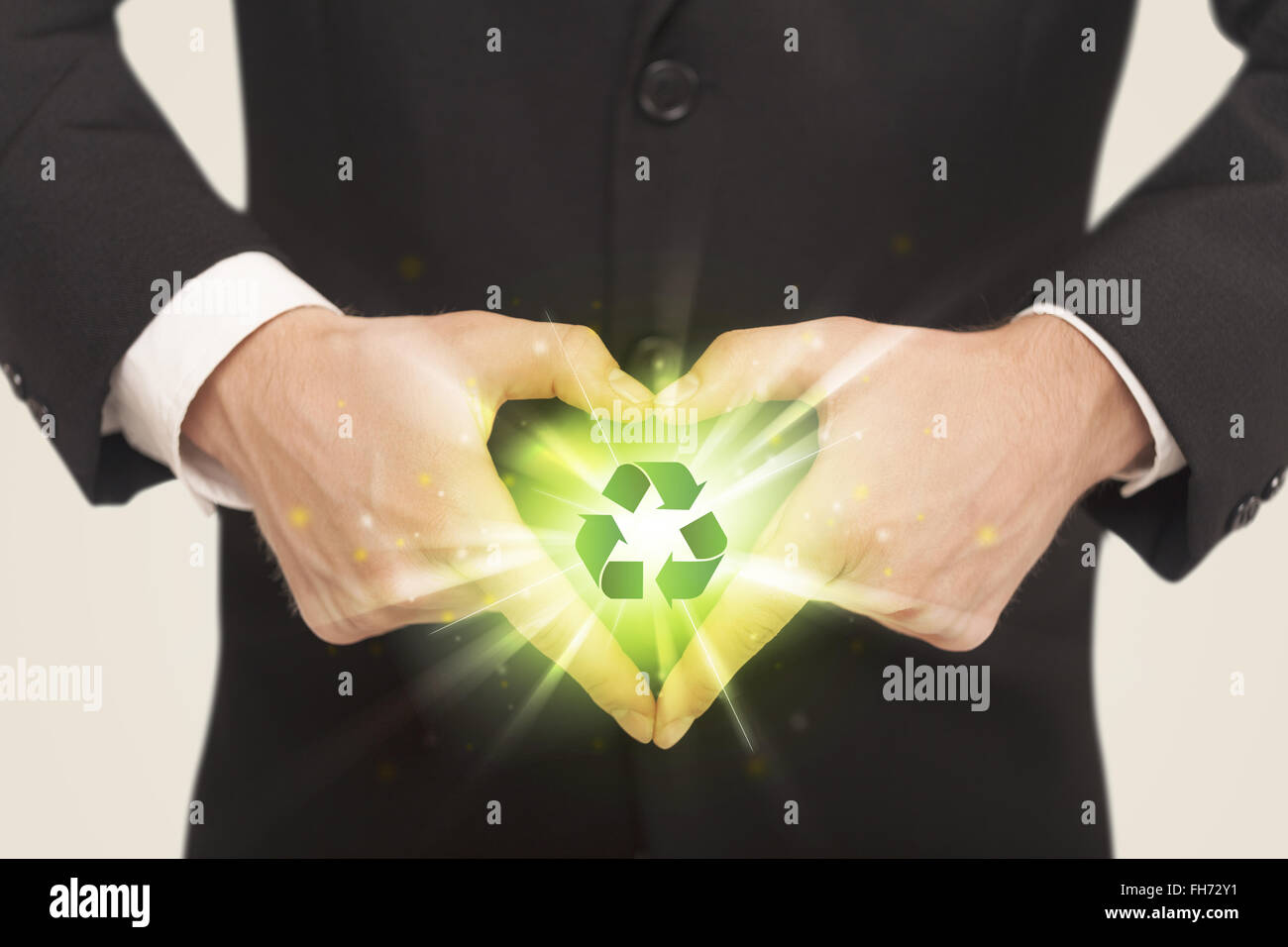 Hands creating a form with recycling sign Stock Photo - Alamy
