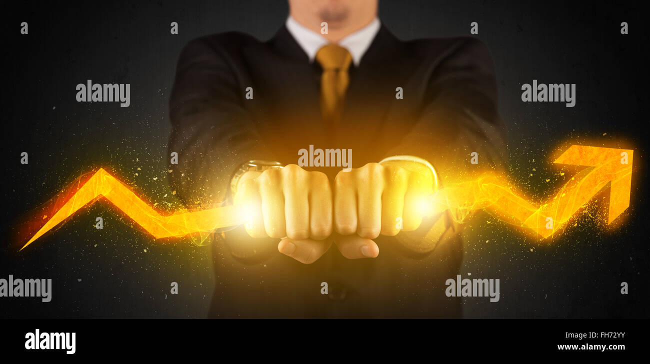 Business person holding a hot glowing upright arrow Stock Photo - Alamy