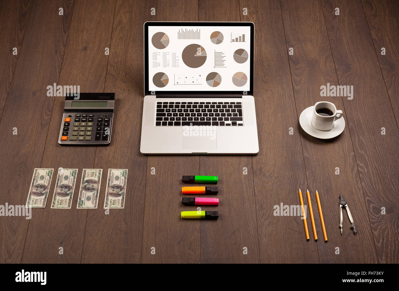 Pie chart graph icons on laptop screen with office accessories Stock ...