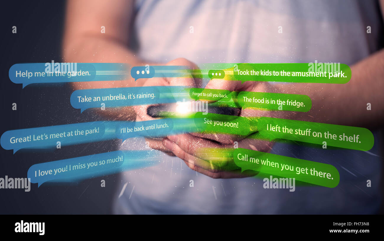 Young man writing messages with smartphone Stock Photo - Alamy