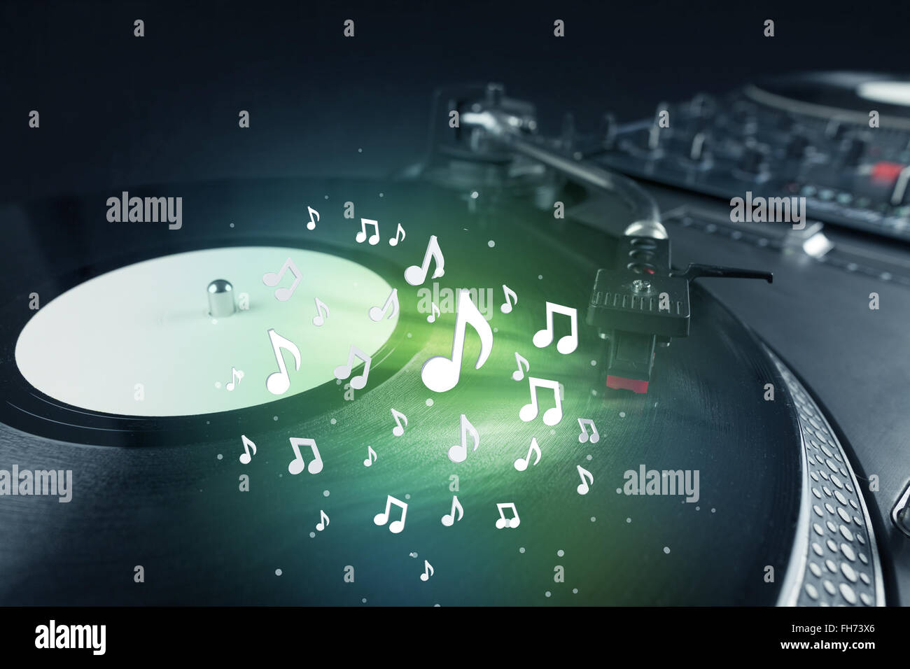 Turntable playing music with audio notes glowing Stock Photo - Alamy