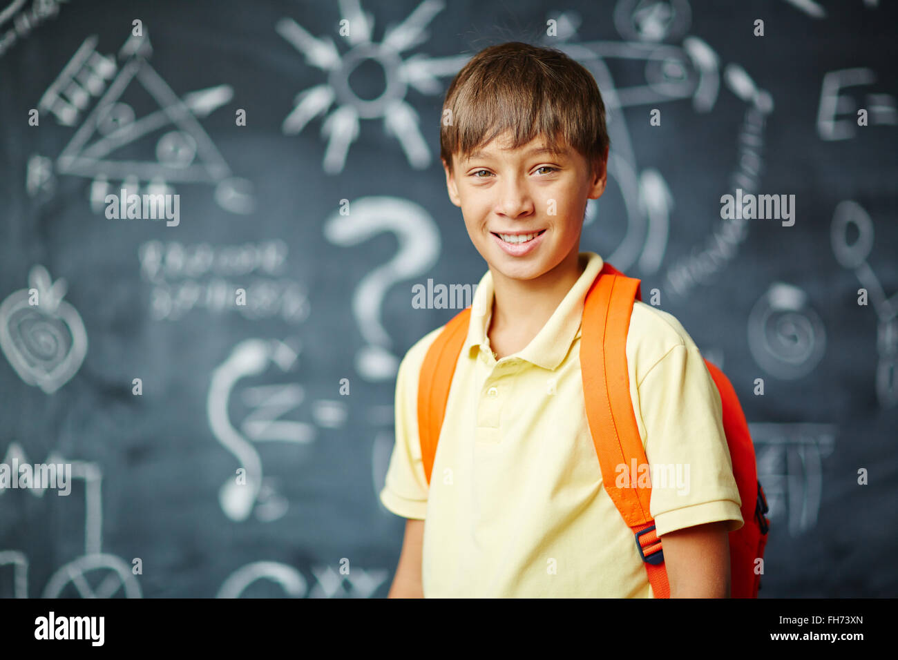 Happy pupil looking at camera with smile Stock Photo - Alamy