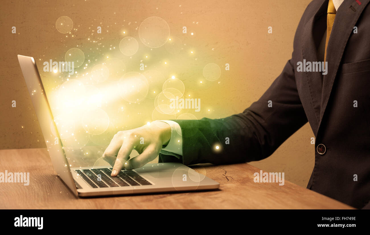 Businessman working fast on laptop Stock Photo - Alamy