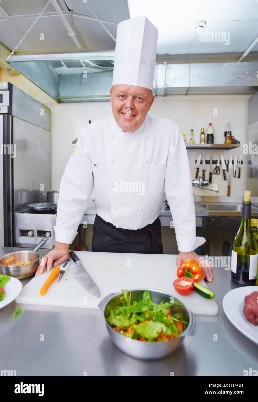 Happy chef looking at camera at workplace Stock Photo - Alamy