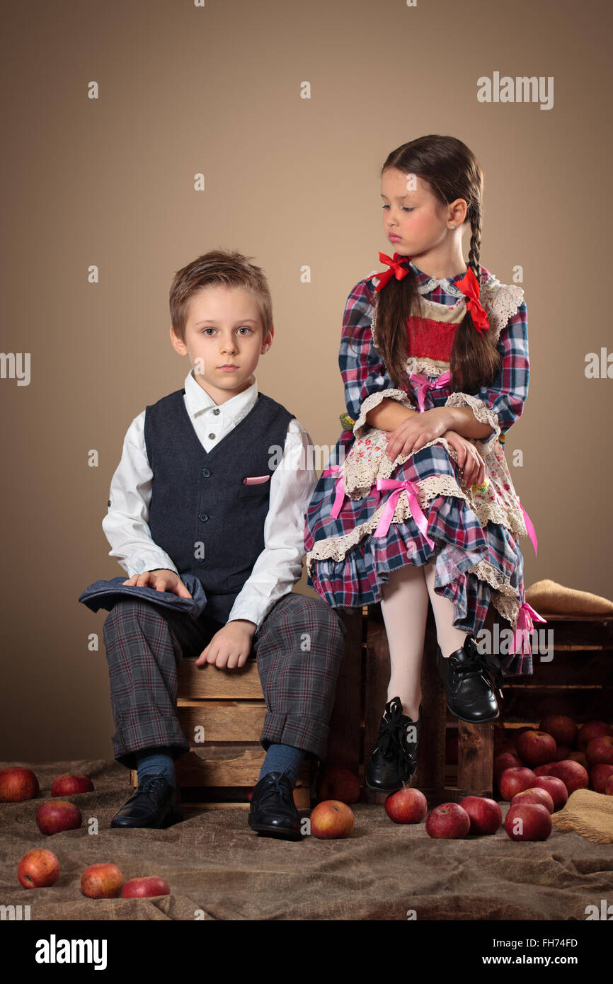 Girl and boy with apples and boxes Stock Photo - Alamy