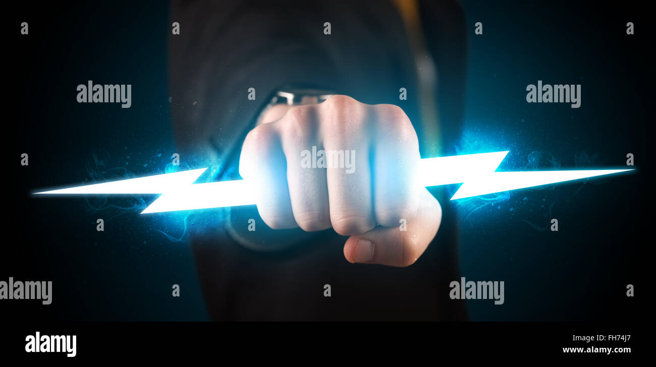 Business man holding glowing lightning bolt in his hands Stock Photo ...