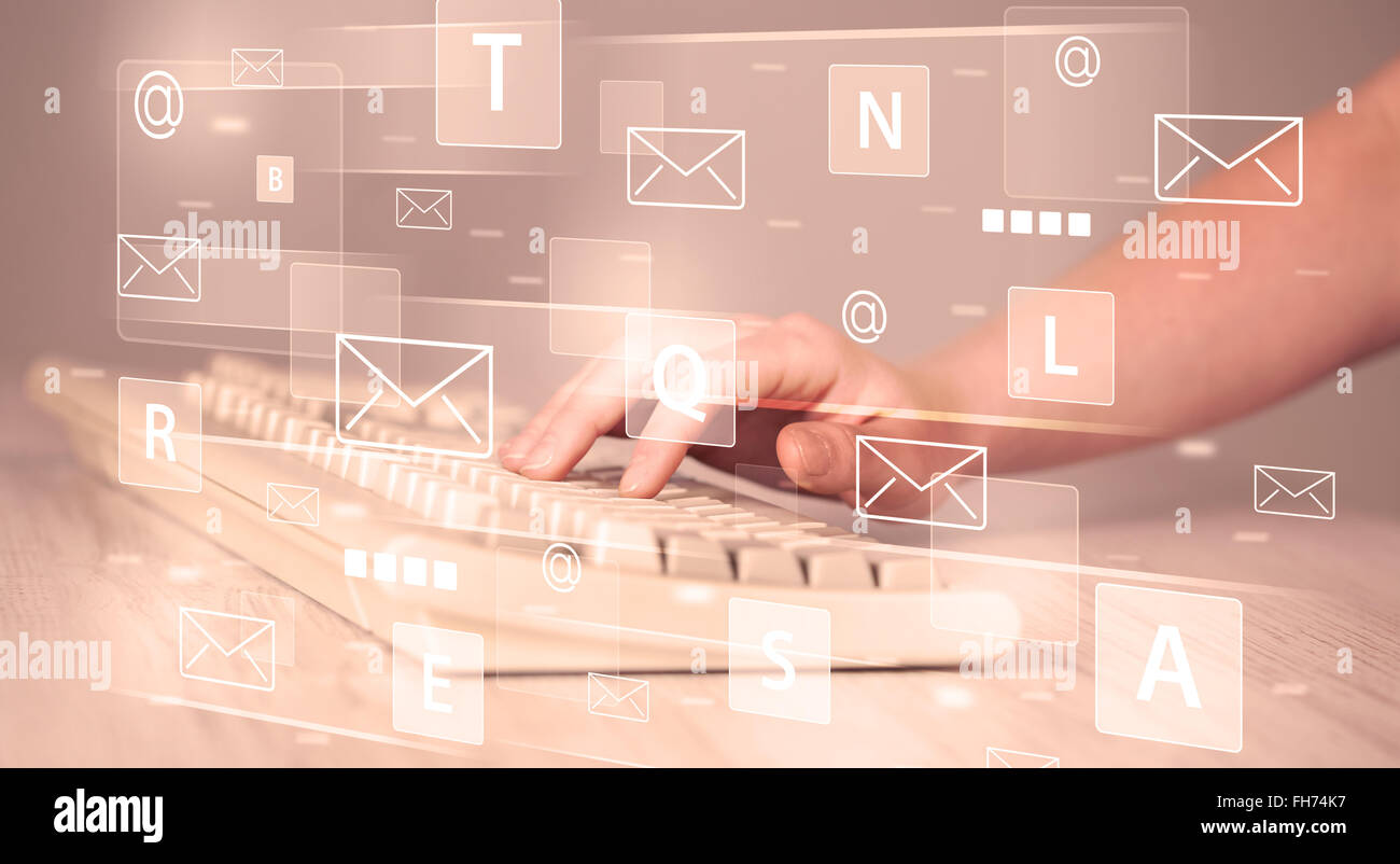 Hand typing on keyboard with digital tech icons Stock Photo - Alamy