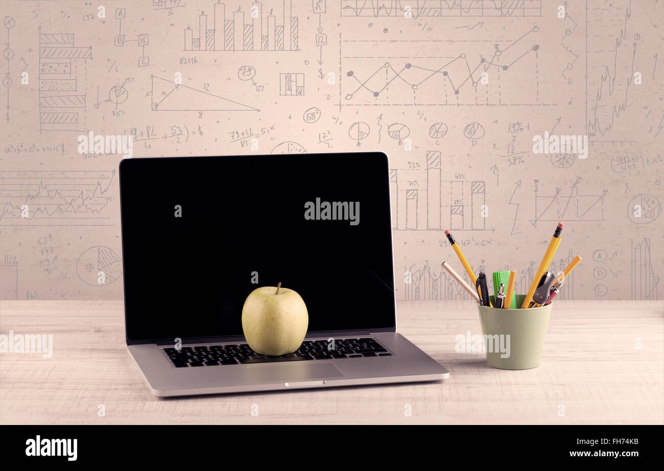 Graph charts and designer office desk Stock Photo - Alamy