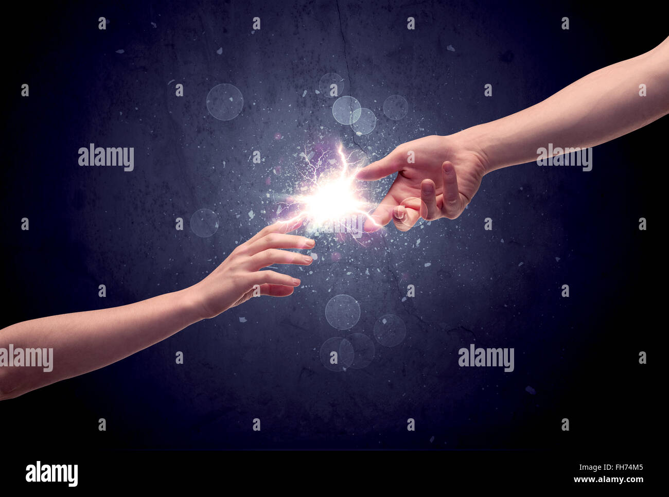 Hands reaching to light a spark Stock Photo - Alamy