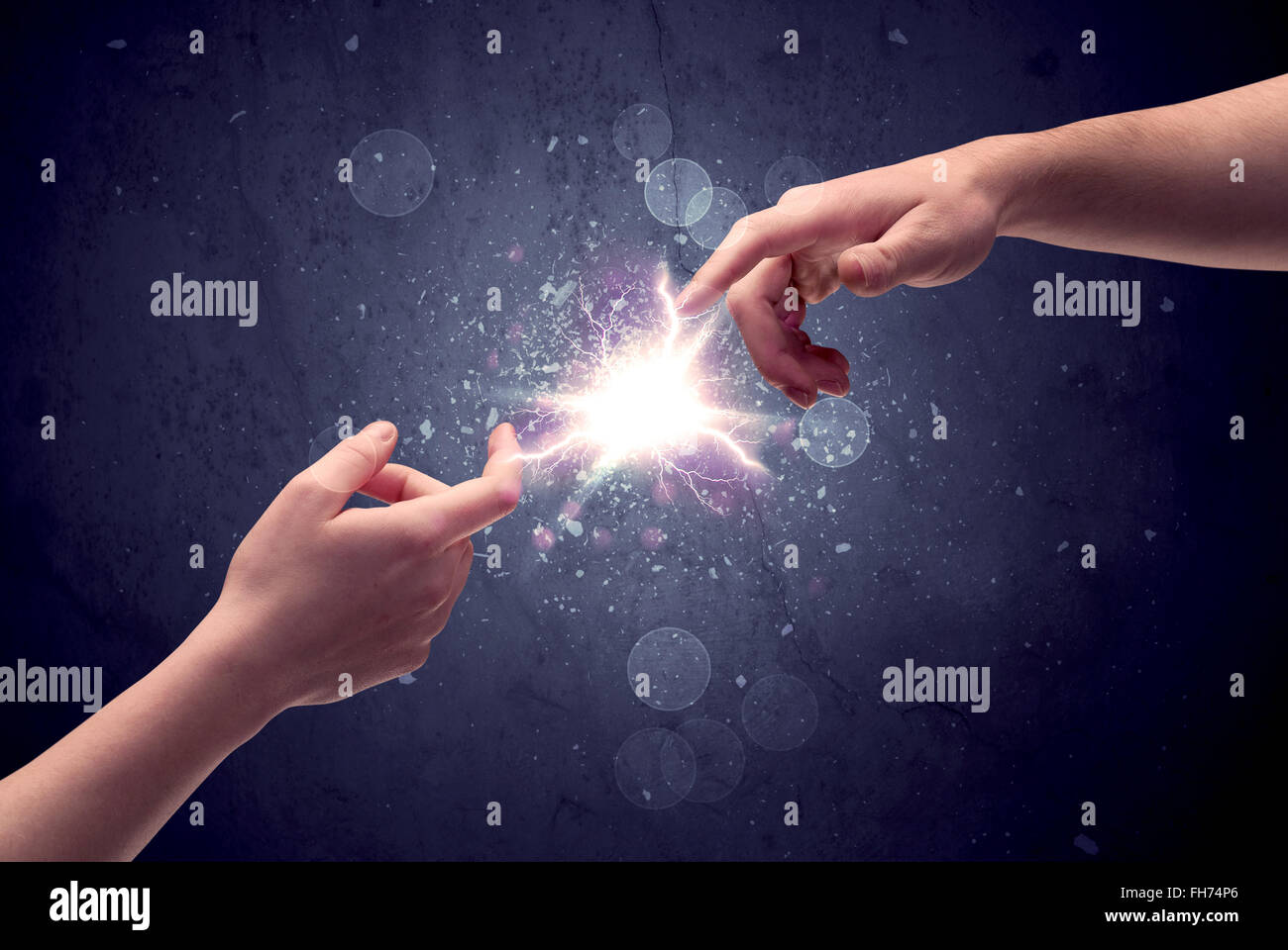 Hands reaching to light a spark Stock Photo - Alamy