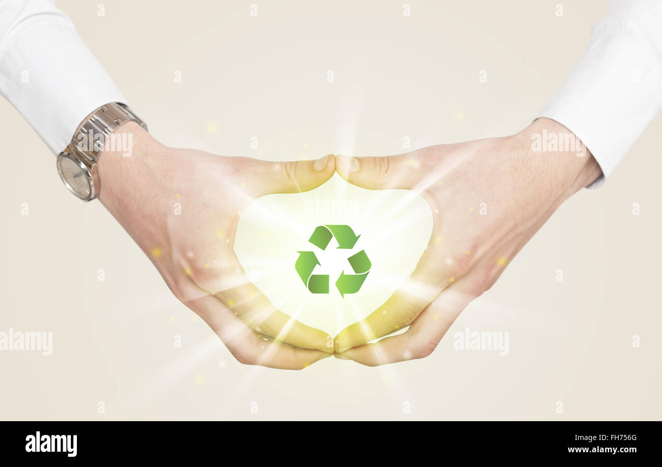 Hands creating a form with recycling sign Stock Photo - Alamy
