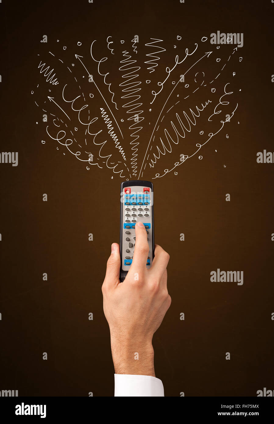 Hand with remote control and curly lines Stock Photo - Alamy