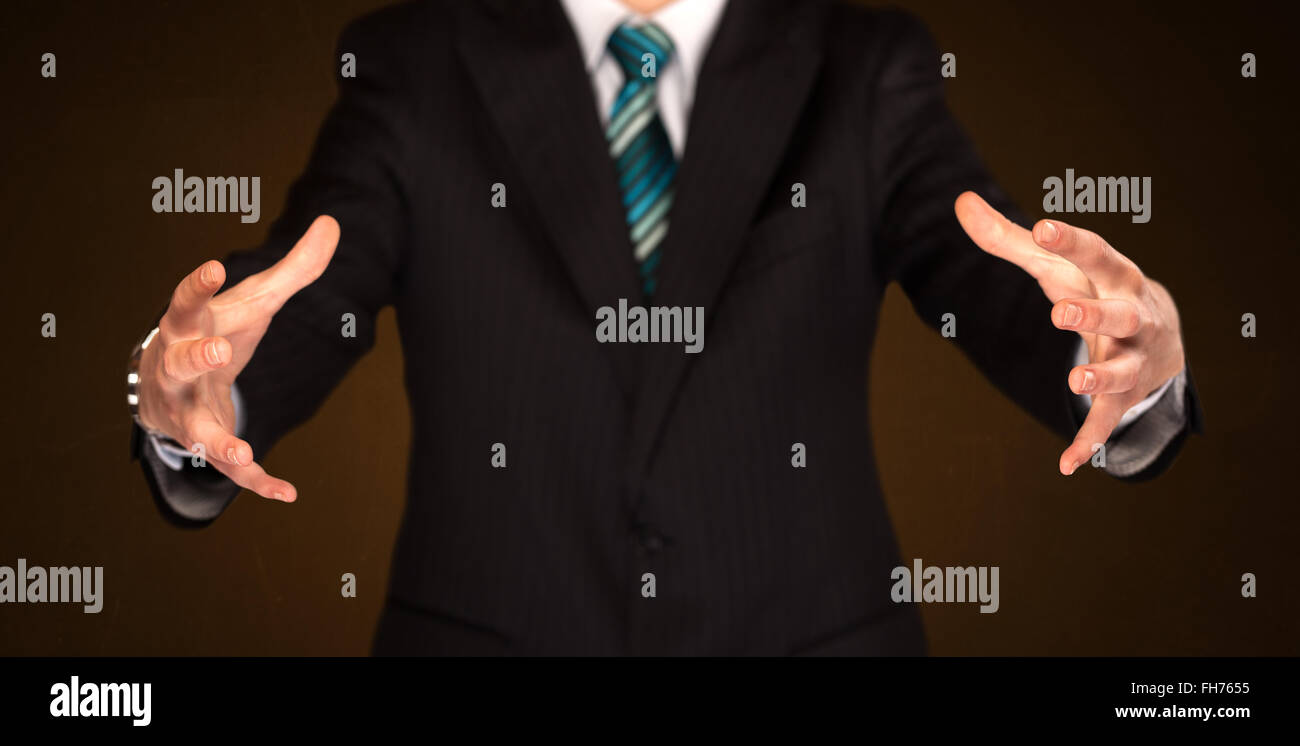 Businessman holding something Stock Photo - Alamy