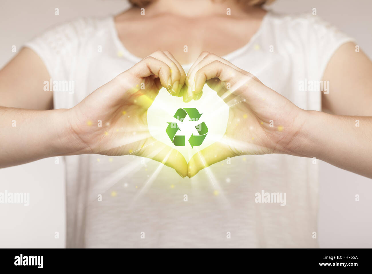 Hands creating a form with recycling sign Stock Photo - Alamy