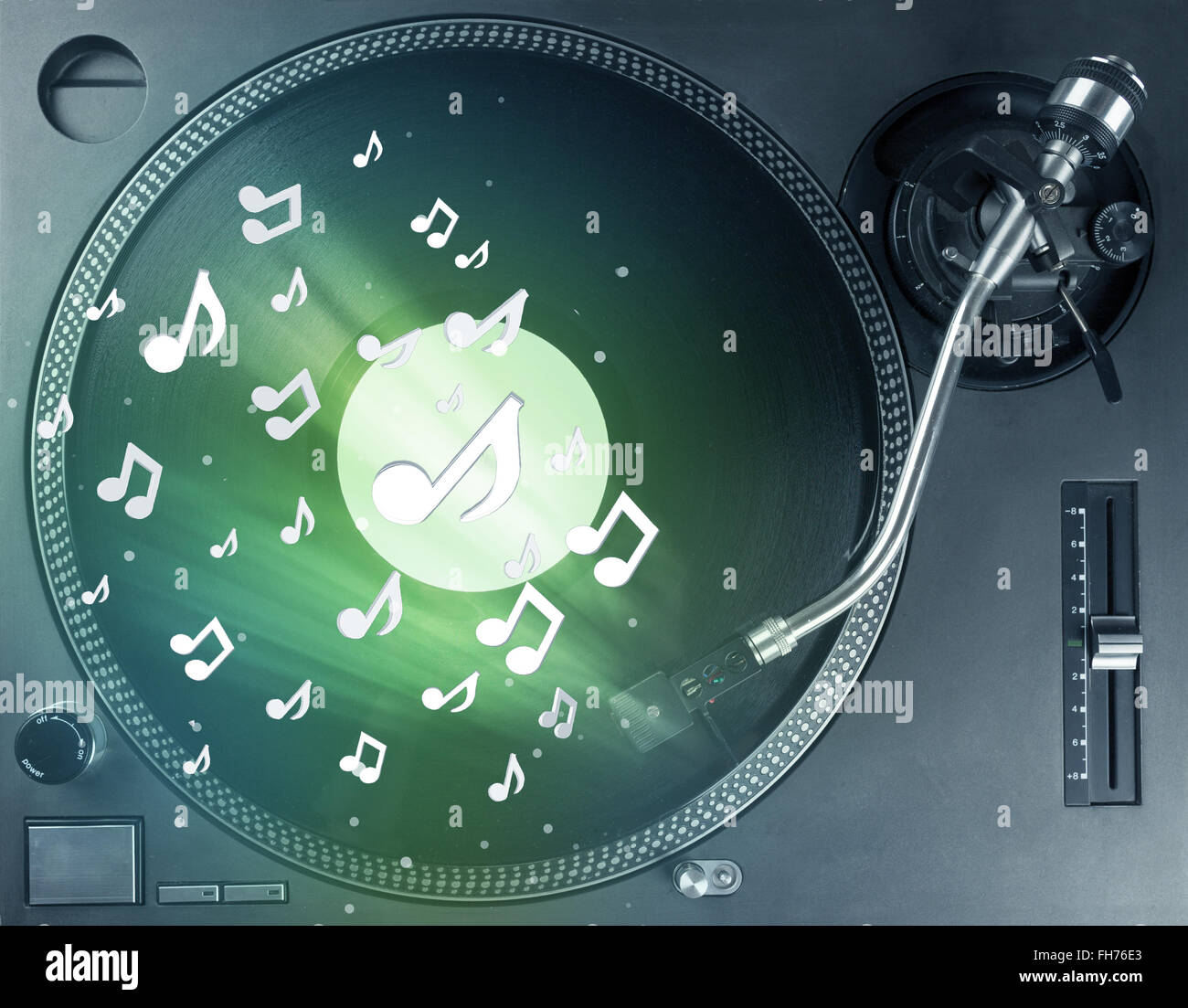 Turntable playing music with audio notes glowing Stock Photo - Alamy