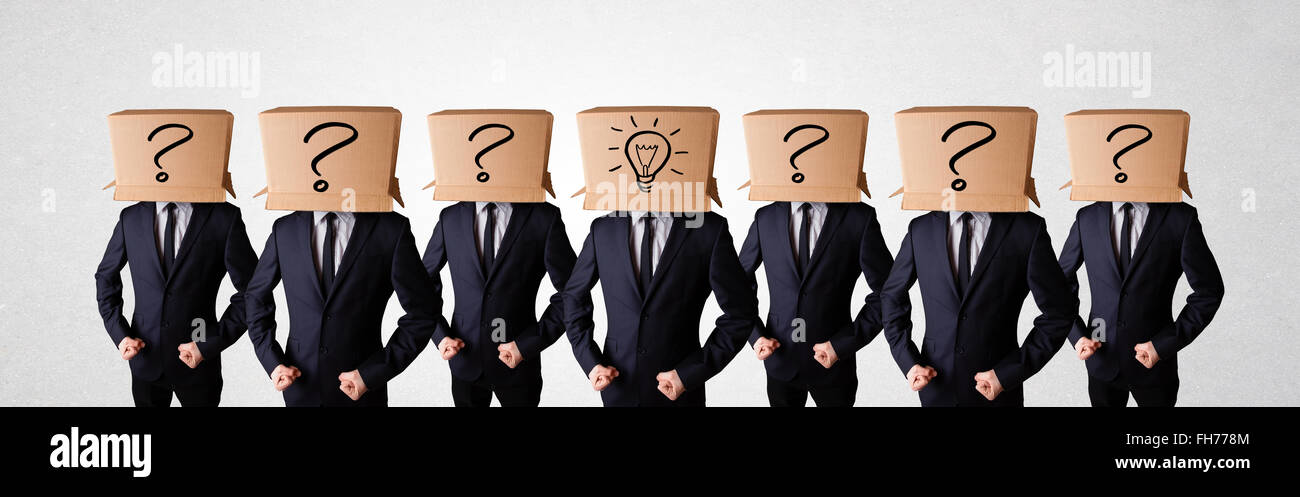 Handsome men in suit gesturing with drawn signs and symbols on box ...