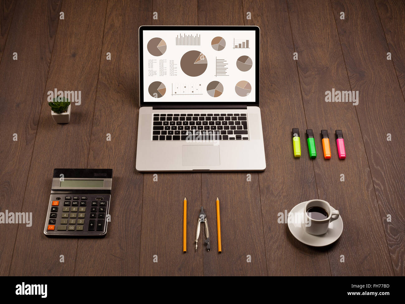 Pie chart graph icons on laptop screen with office accessories Stock ...