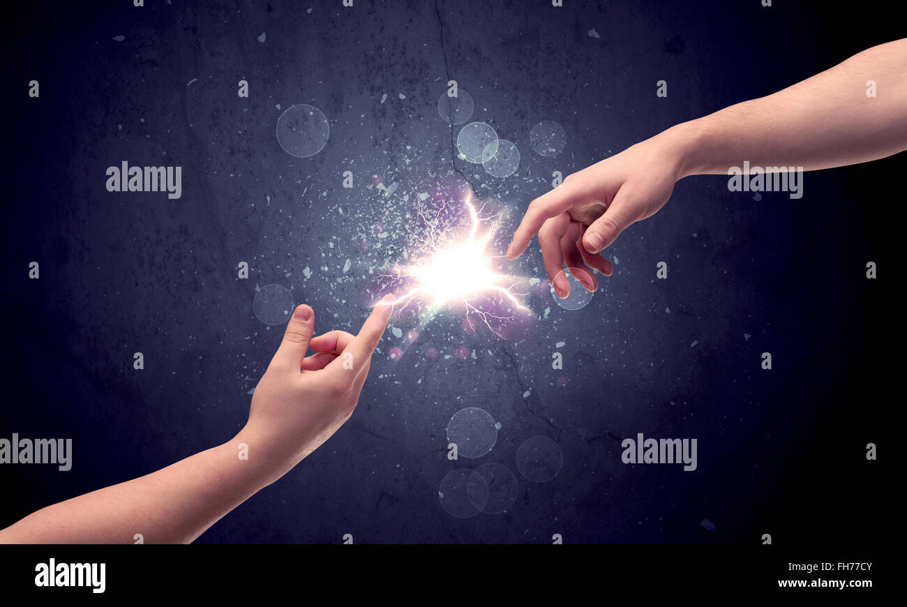 Hands reaching to light a spark Stock Photo - Alamy