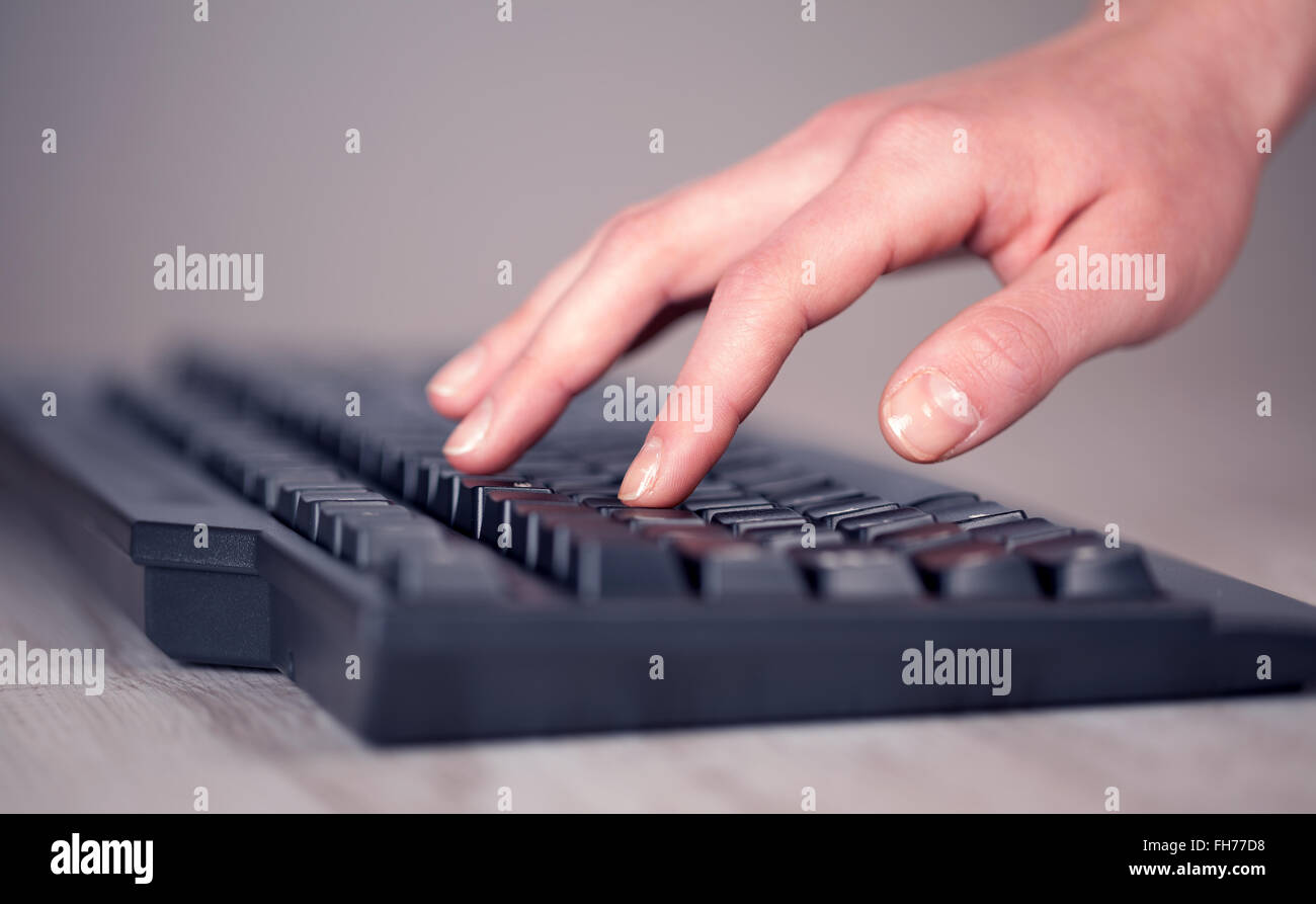 Close up of hand pressing keyboard buttons Stock Photo - Alamy