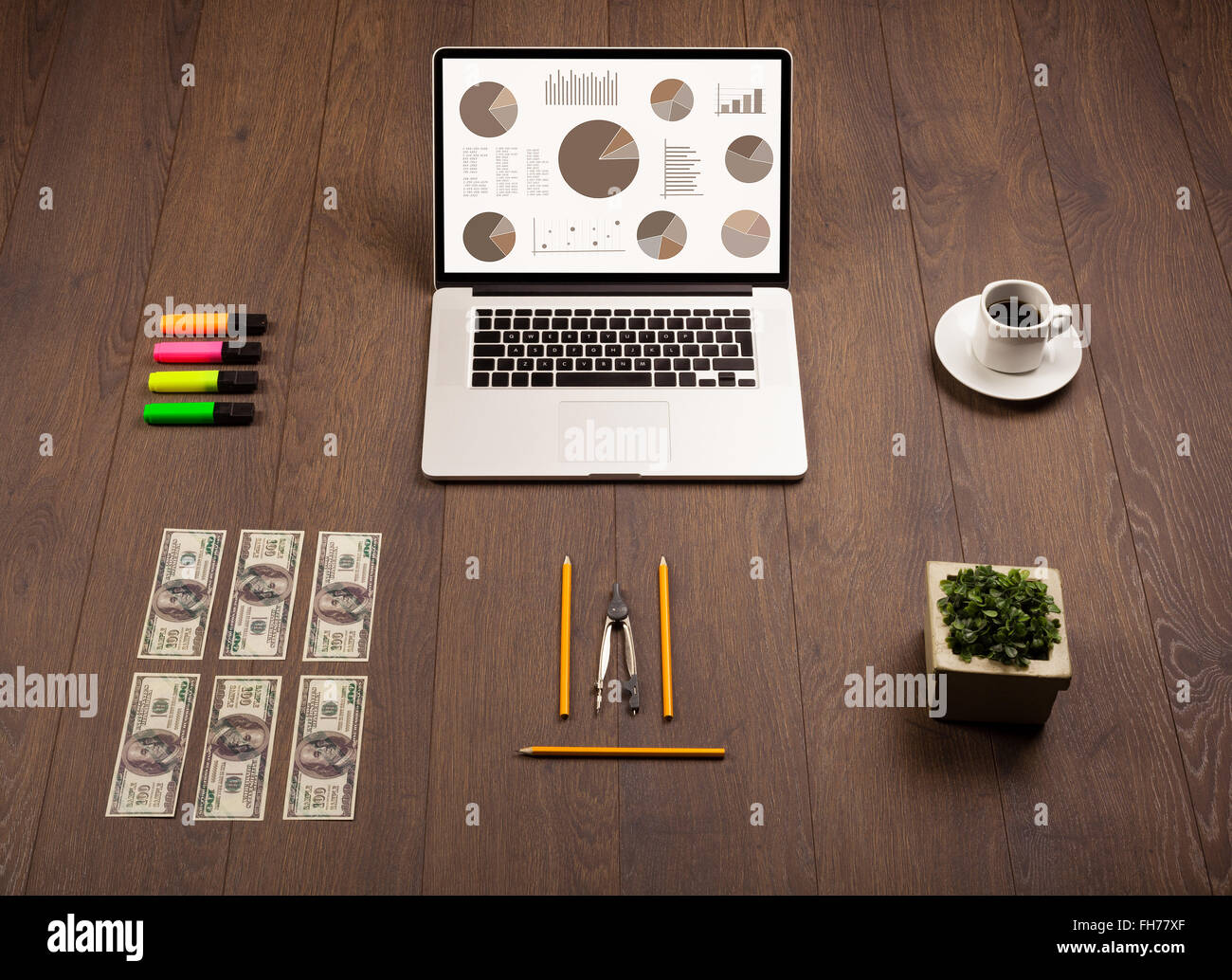 Pie chart graph icons on laptop screen with office accessories Stock ...