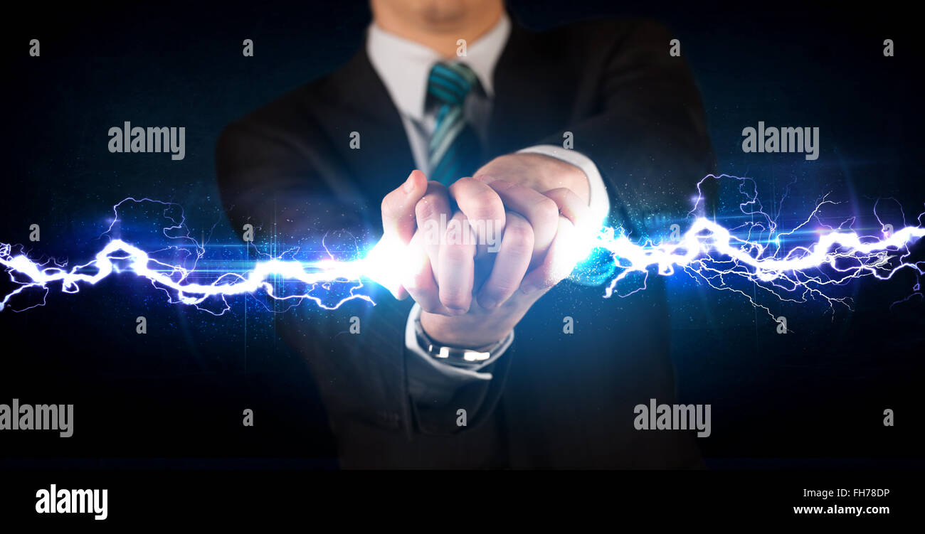 Business man holding electricity light bolt in his hands Stock Photo ...