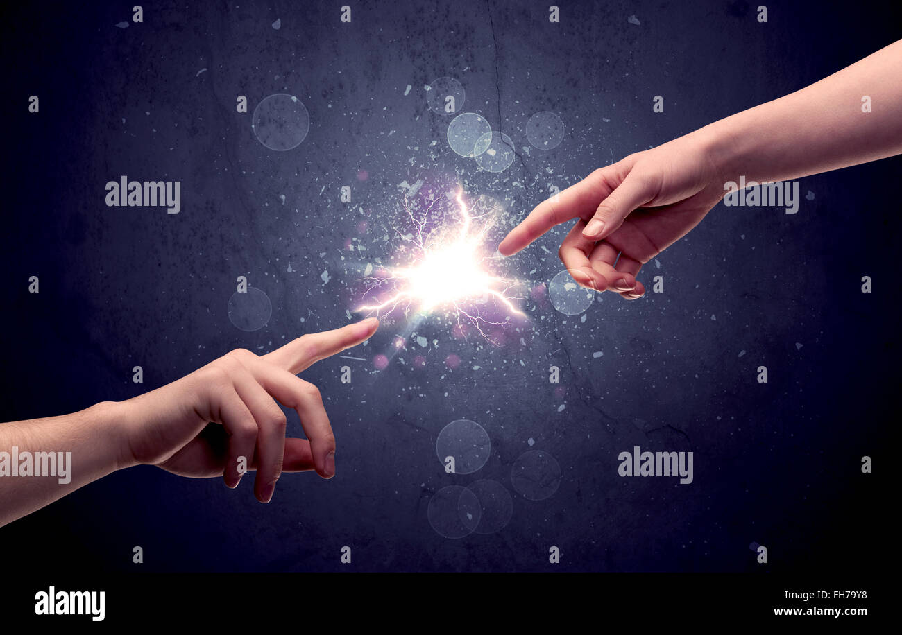 Hands reaching to light a spark Stock Photo - Alamy