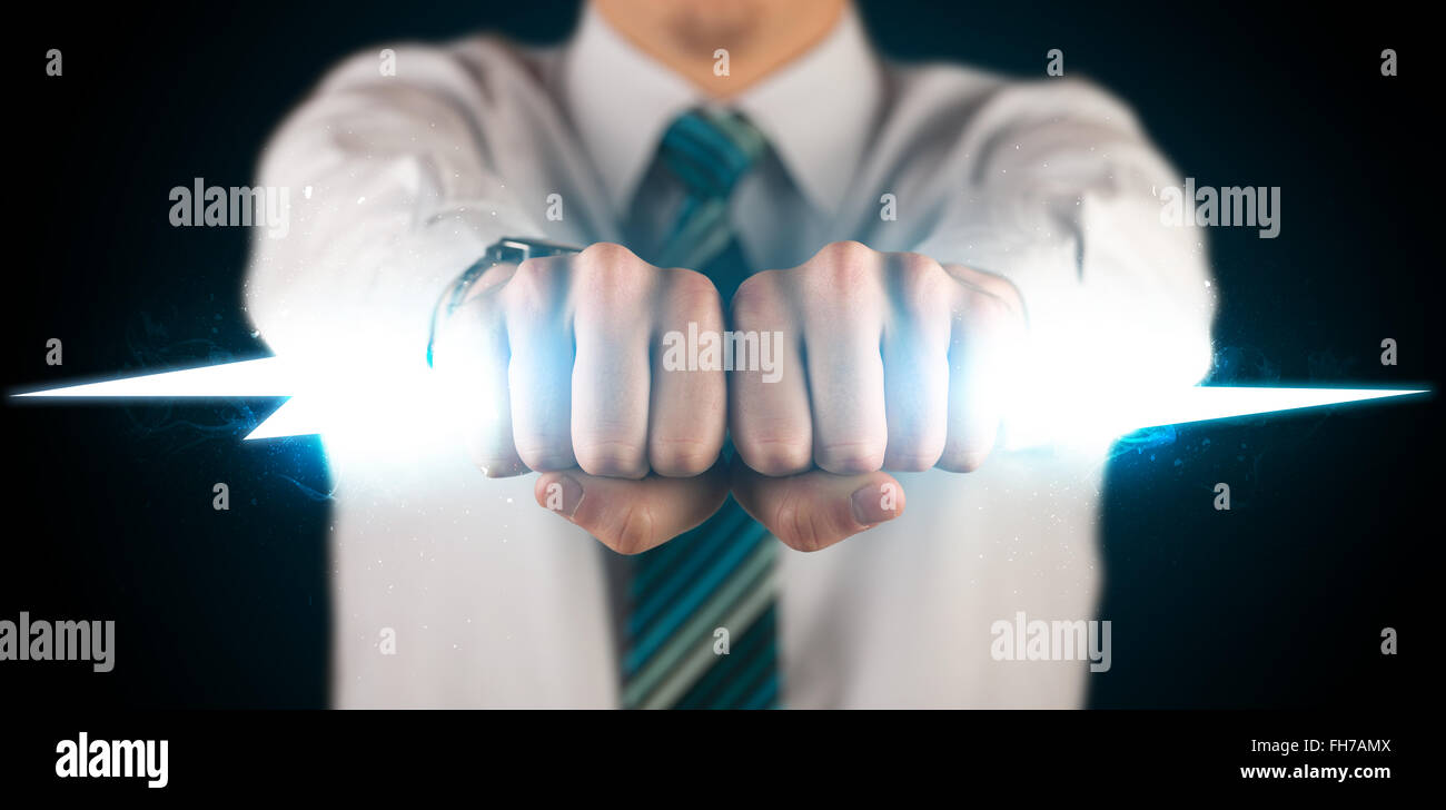 Business man holding glowing lightning bolt in his hands Stock Photo ...
