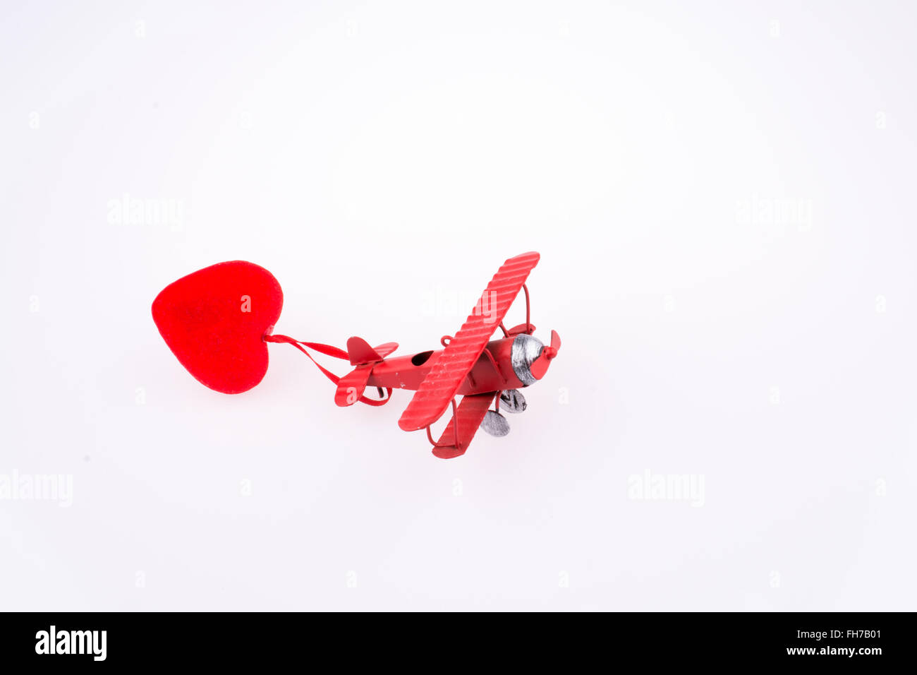 Red plane flying a red heart Stock Photo - Alamy