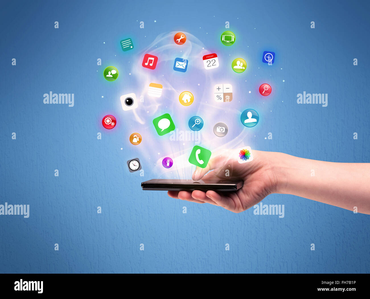 Hand holding tablet phone with app icons Stock Photo - Alamy