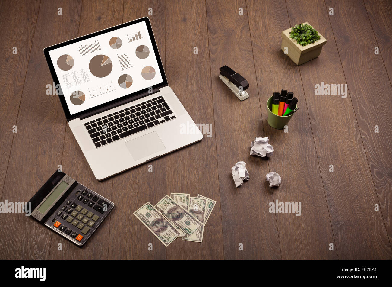 Pie chart graph icons on laptop screen with office accessories Stock ...