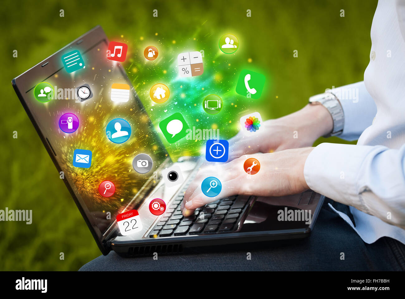Hand pressing modern laptop with mobile app icons and symbols Stock ...