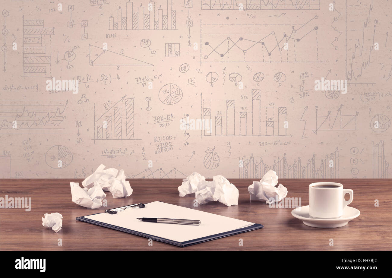 Graph charts and designer office desk Stock Photo - Alamy