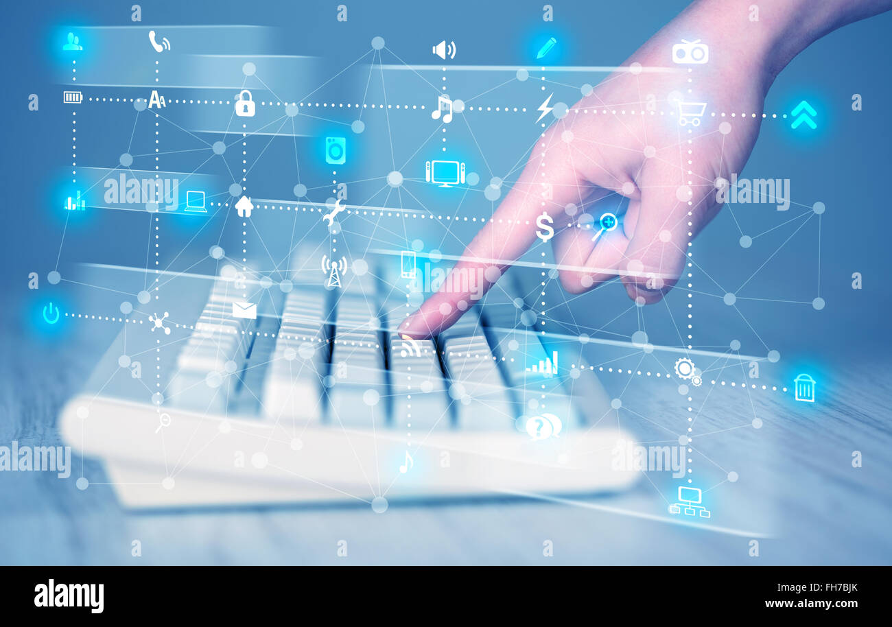 Hand pressing keyboard with high tech media icons Stock Photo - Alamy
