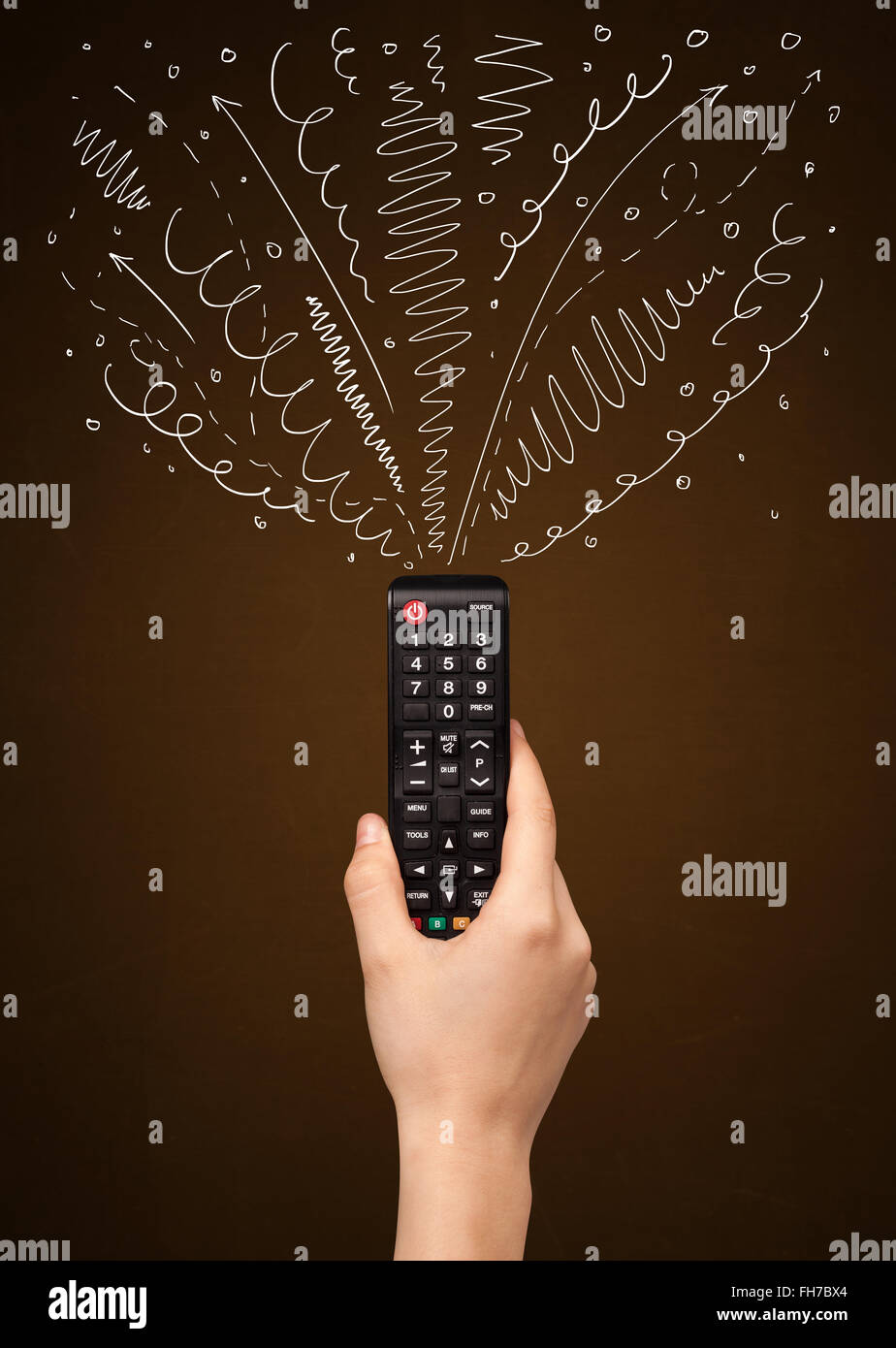 Hand with remote control and curly lines Stock Photo - Alamy