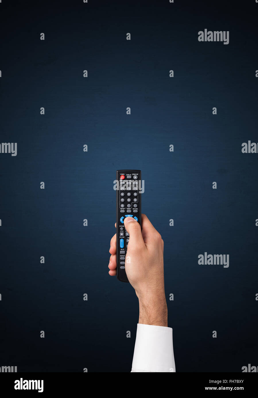 Hand with remote control Stock Photo - Alamy
