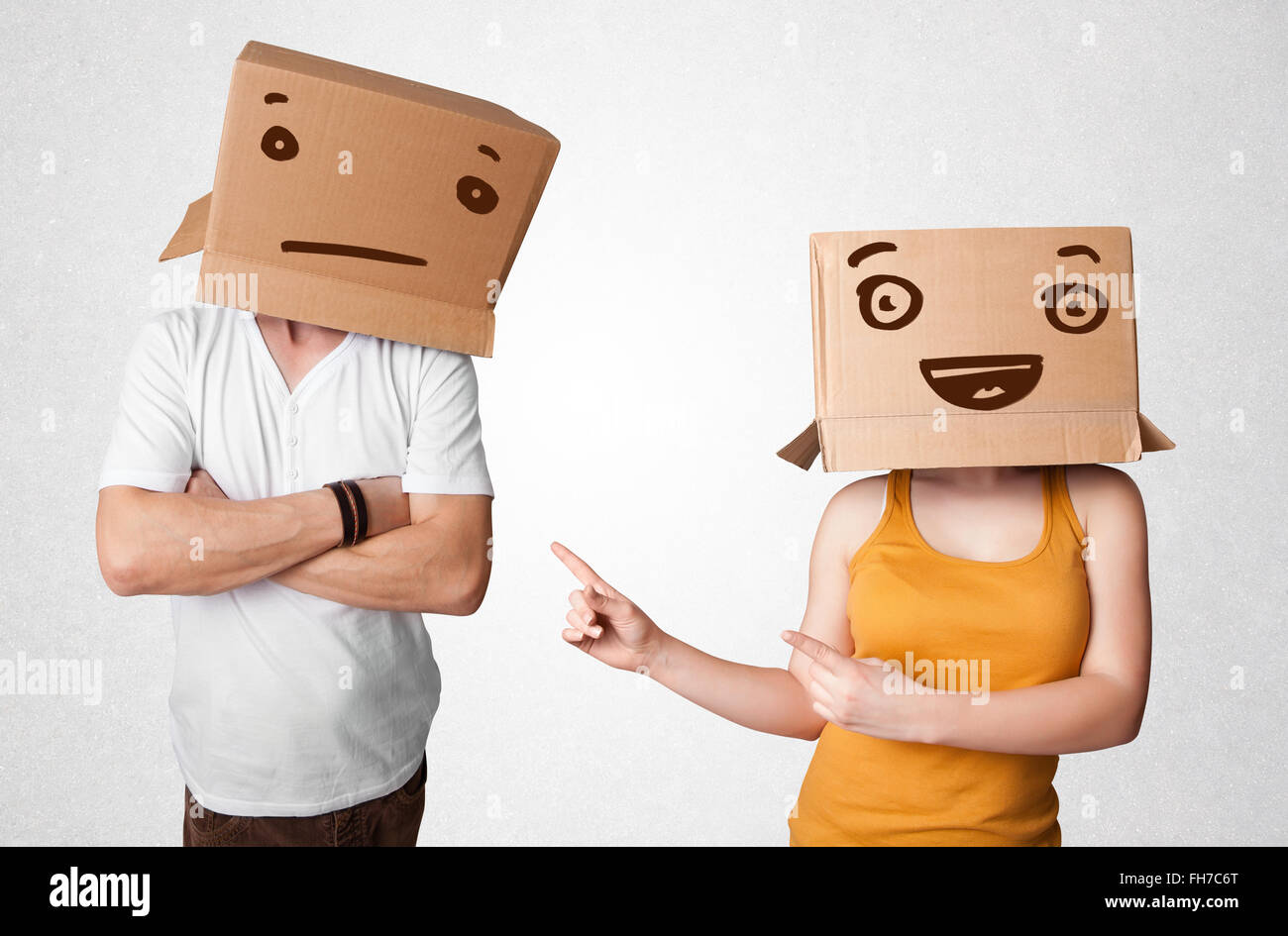 Handsome men in suit gesturing with drawn smiley faces on box Stock ...