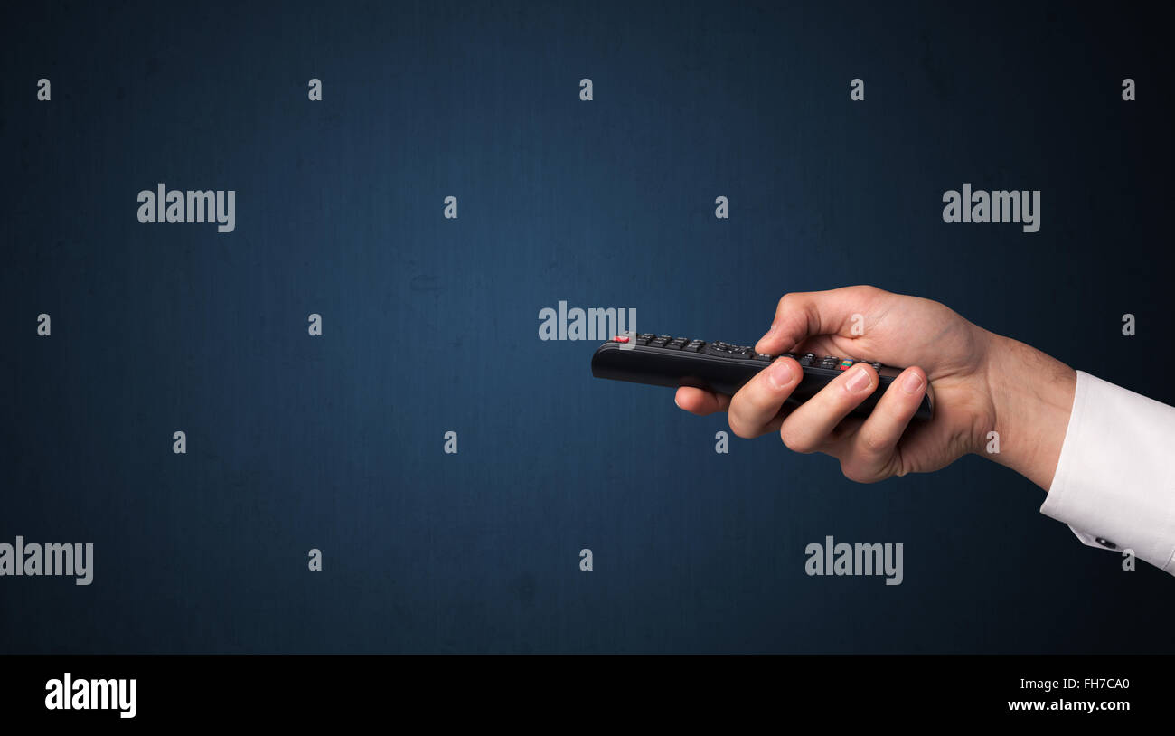 Hand with remote control Stock Photo - Alamy