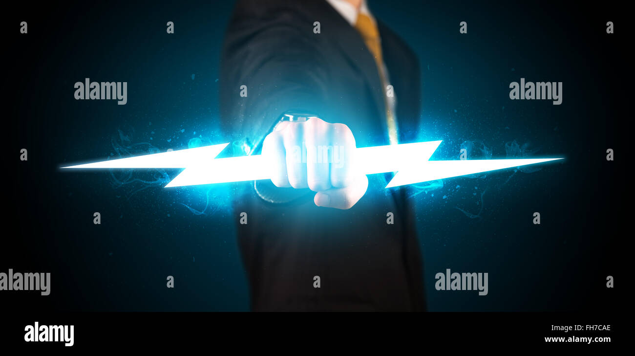 Business man holding glowing lightning bolt in his hands Stock Photo ...