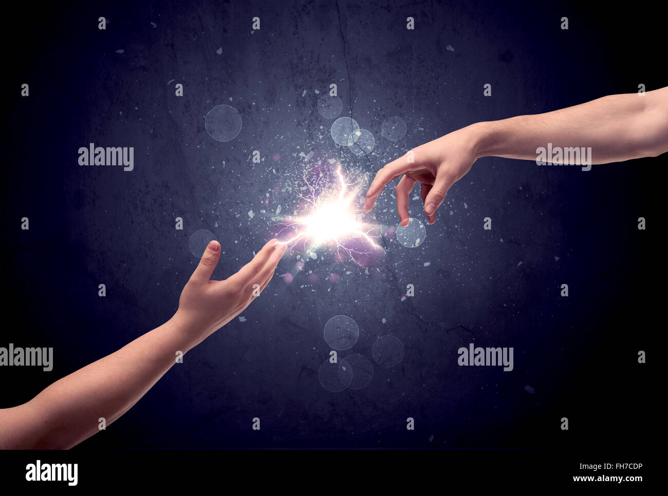 Hands reaching to light a spark Stock Photo - Alamy